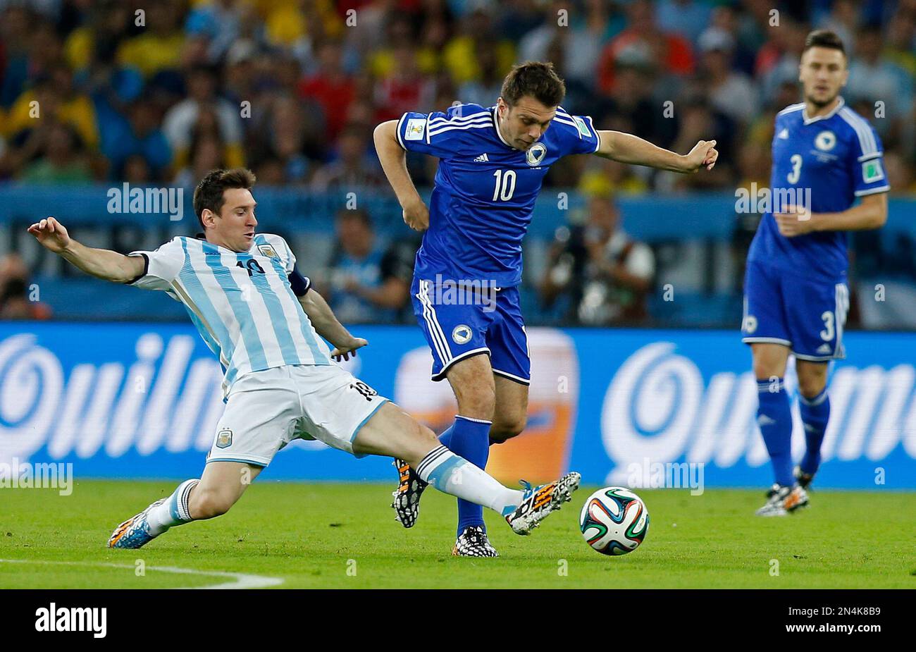 Argentina's Lionel Messi, left, fouls Bosnia's Zvjezdan Misimovic ...