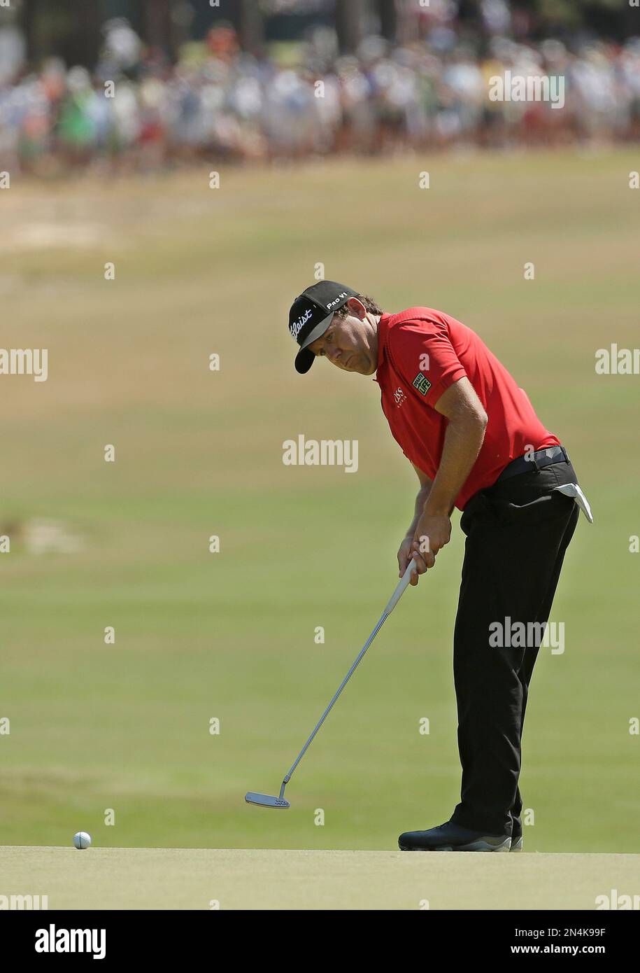Erik Compton watches his putt on the first hole during the final round ...