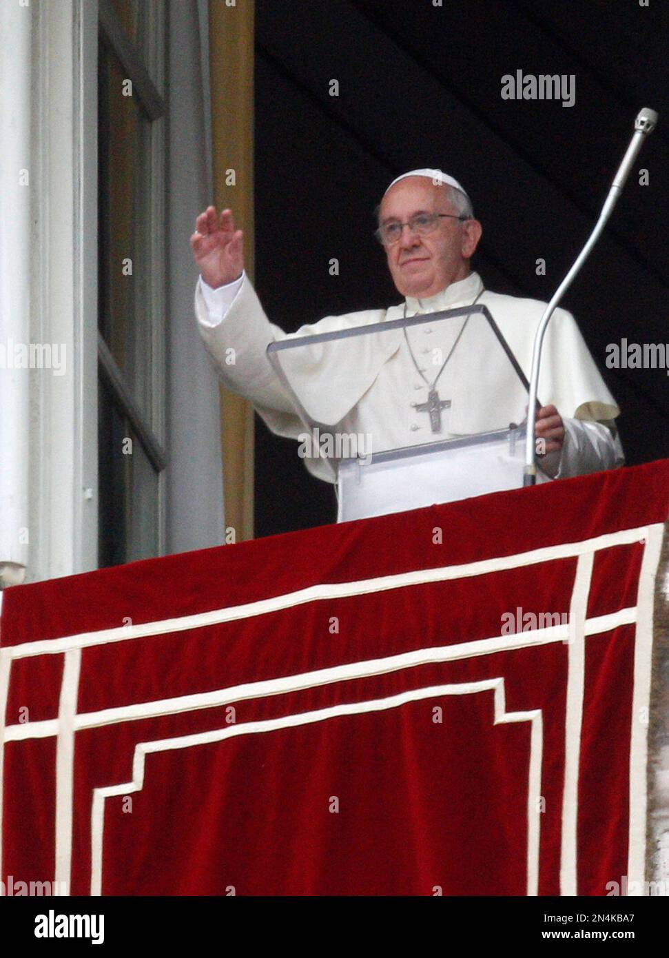 Pope Francis waves to faithful from his studio window overlooking St ...
