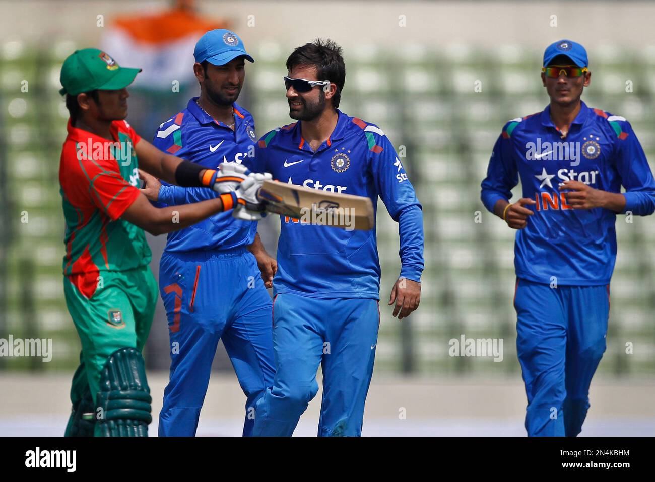 India's Parvez Rasool, second right, celebrates the wicket of ...