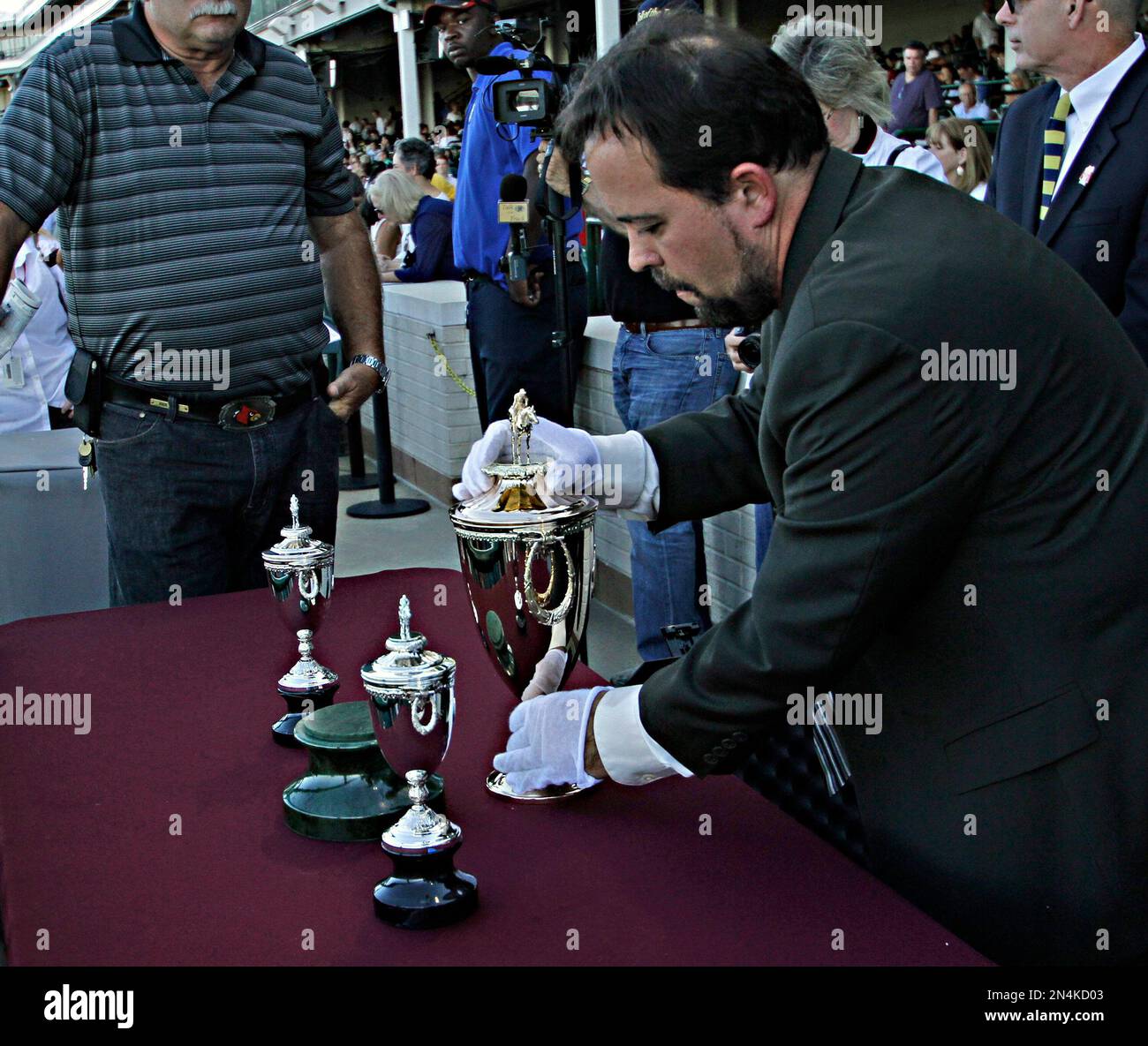 Kentucky Derby Museum curator Chris Goodlett, right, puts the engraved ...