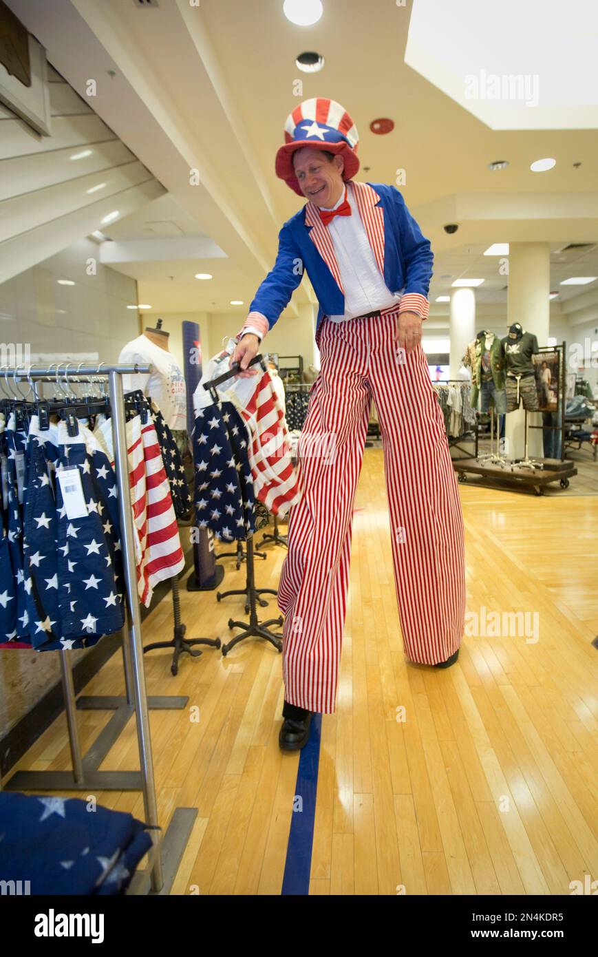 Stilt walker John Scheurich, from Chicago, checks out a pair of ...