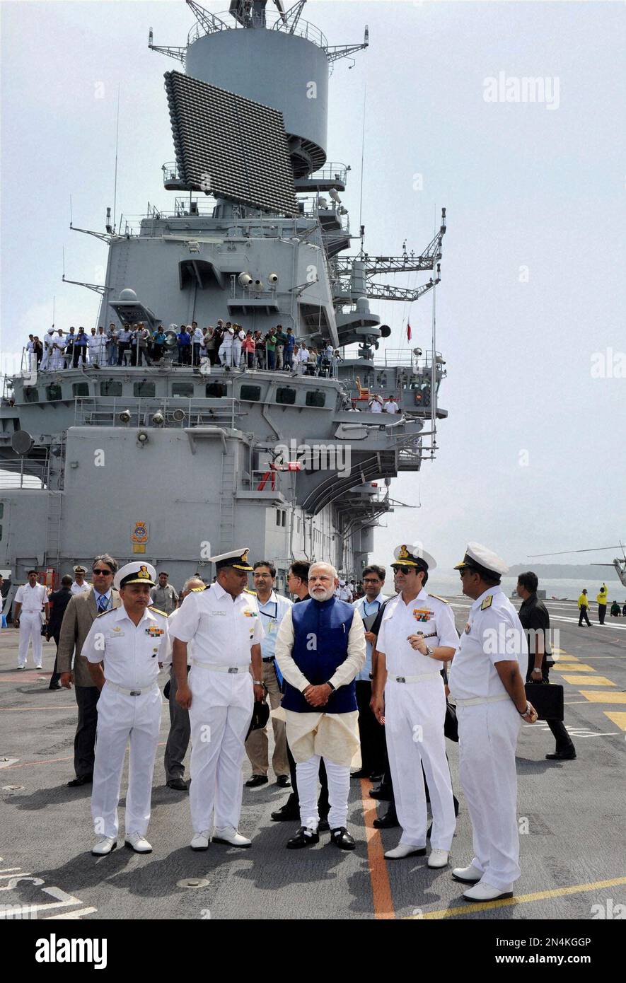 India’s Prime Minister Narendra Modi, center, stands at the naval ...