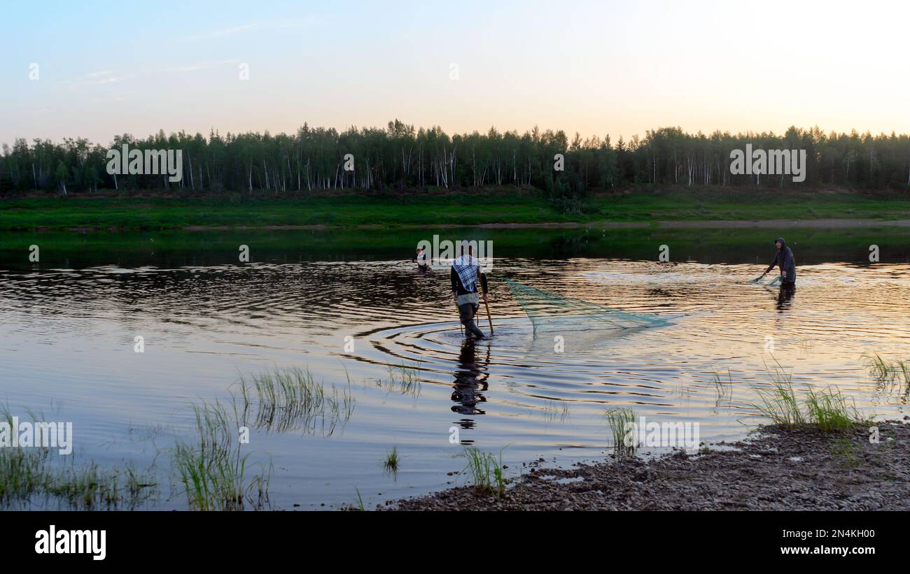 Two men Yakuts and graceful girl in a shawl to go wading boots dragnet ...