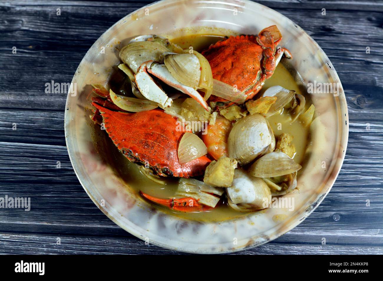 Hot soup meal of various fresh seafood marine crabs, shrimps, clams ...