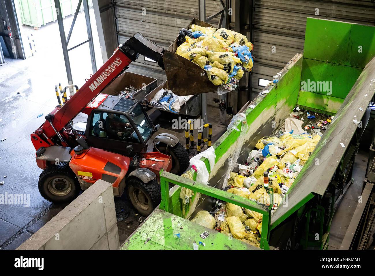 Backhoe loader seen during work at the modernized waste sorting plant ...