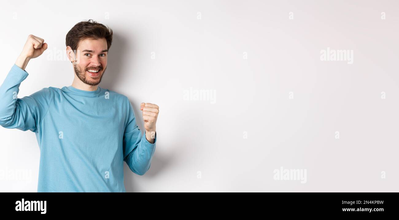 Happy bearded man celebrating victory, raising hands up and triumphing ...