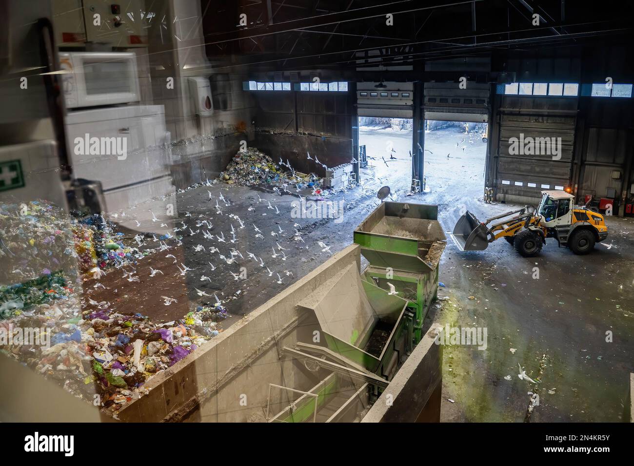 Backhoe loader seen during work at the modernized waste sorting plant ...
