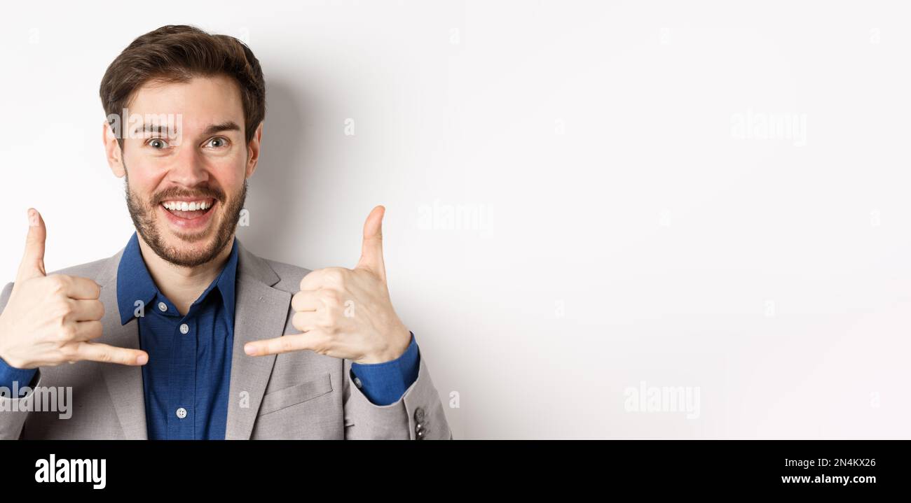 Excited salesman smiling, showing phone signs and asking to give him ...