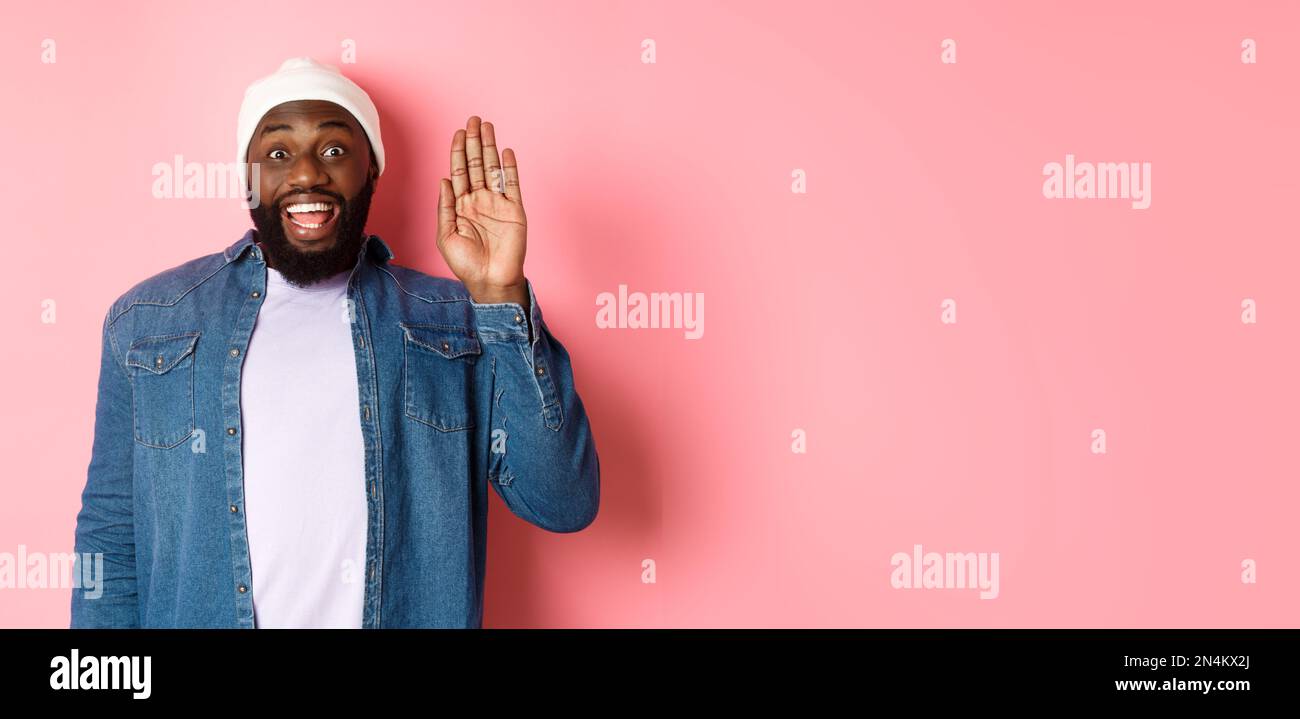 Friendly smiling Black man saying hello, waving hand, greeting you ...