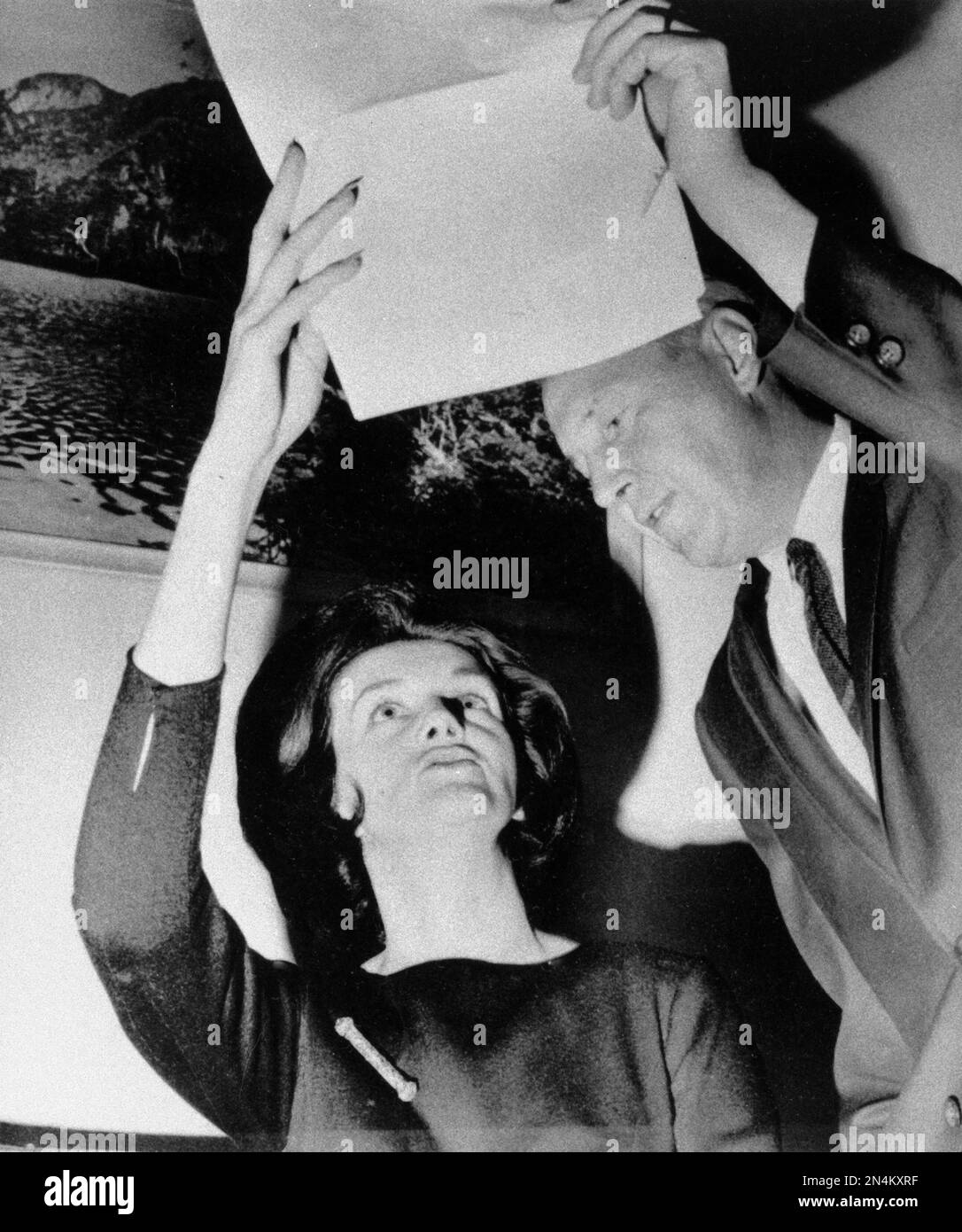 Lucille Miller and her attorney, Edward P. Foley, examine a list of 55 ...
