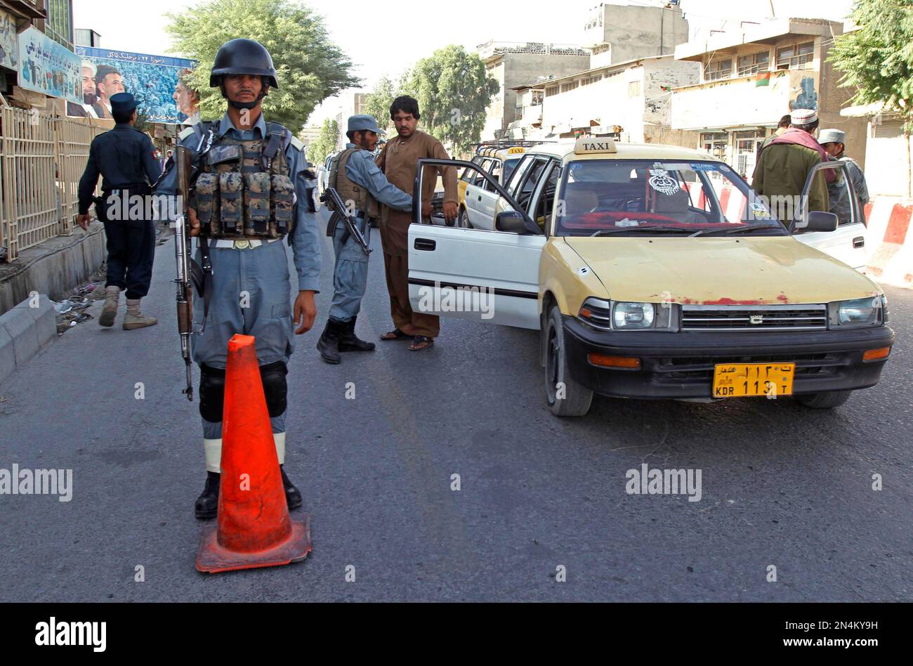 Afghanistan police search passengers at a checkpoint in Kandahar, south ...