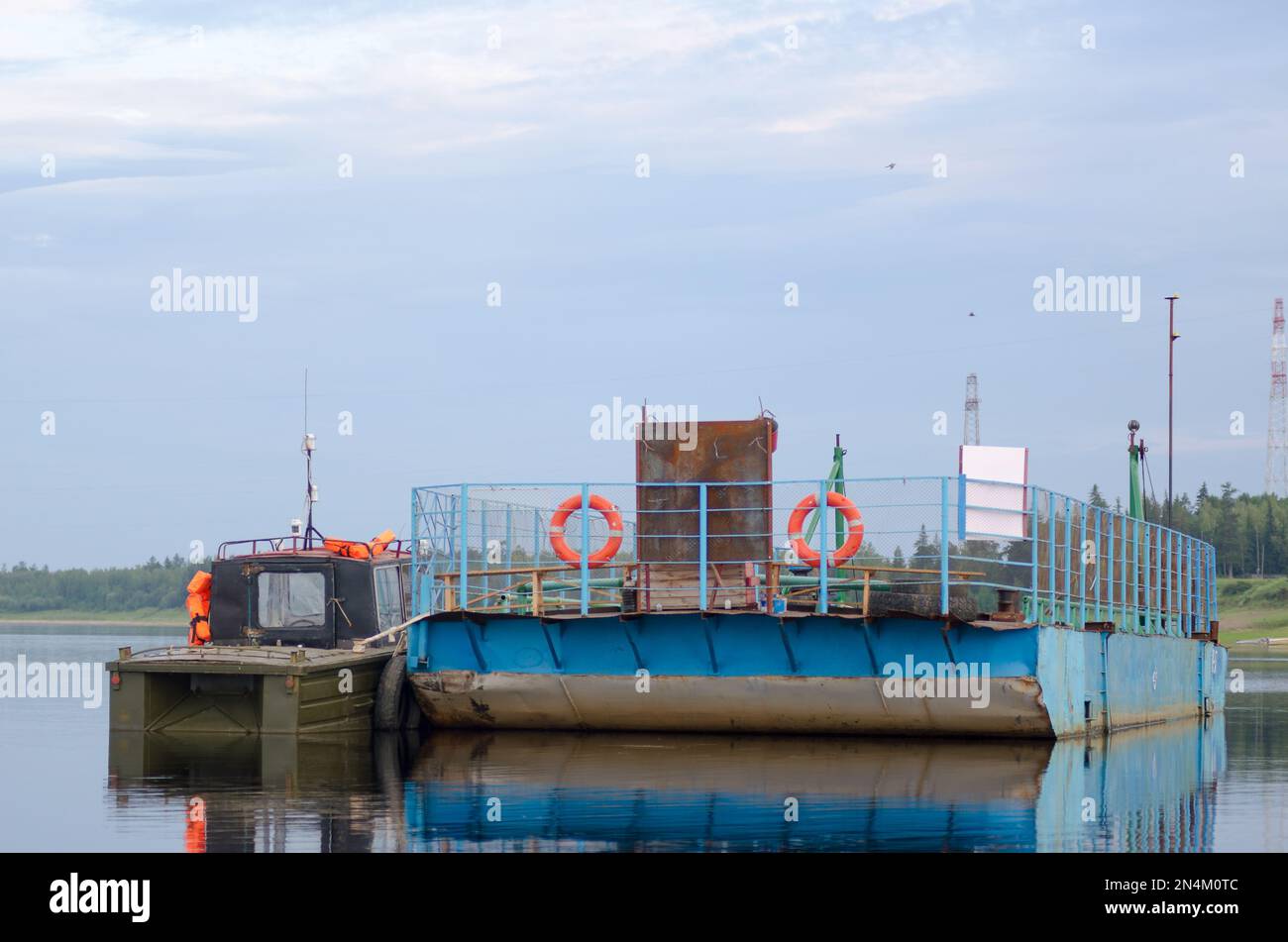 Empty tractor ferry with life jackets and circles stands in the calm ...