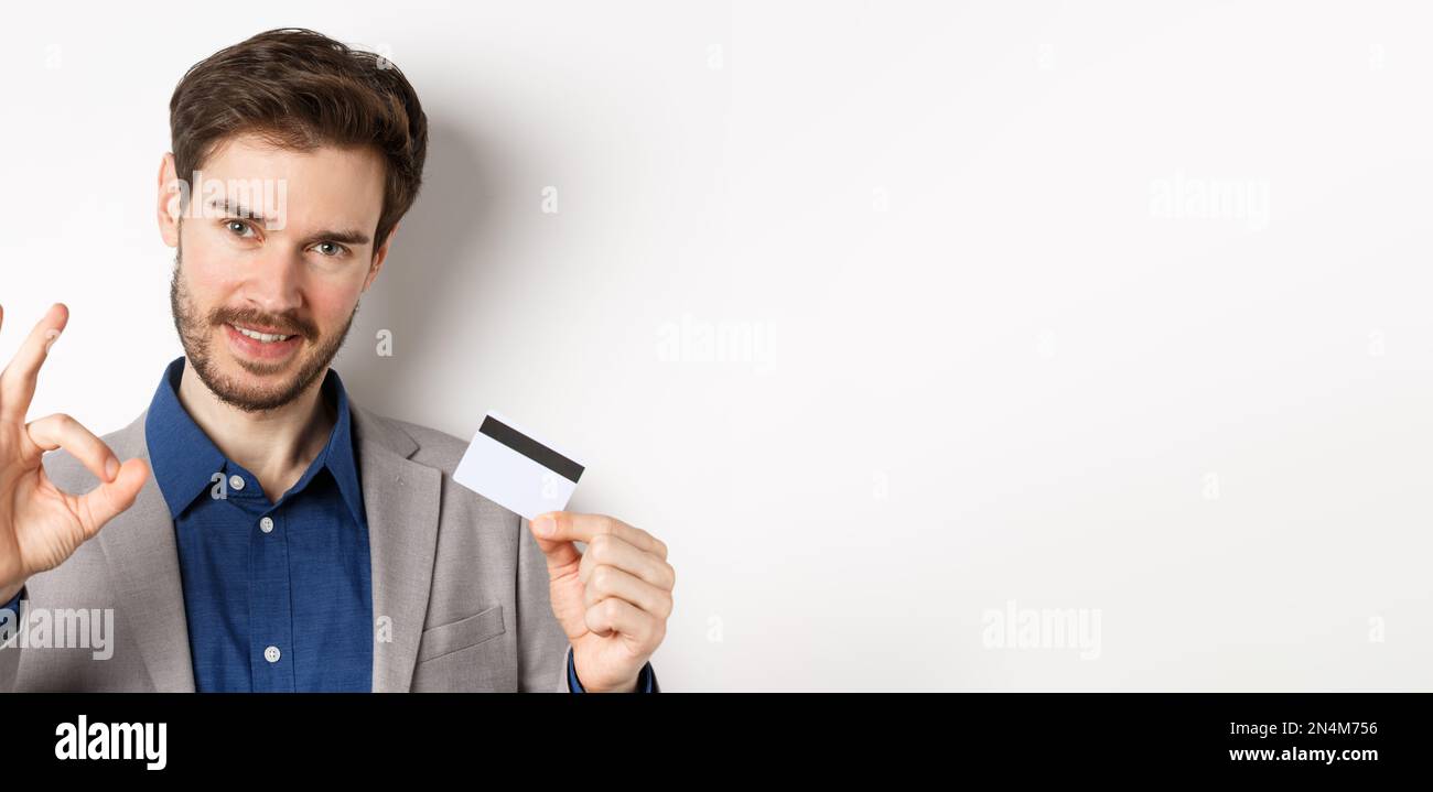 Shopping. Handsome man showing okay sign and plastic credit card, all ...