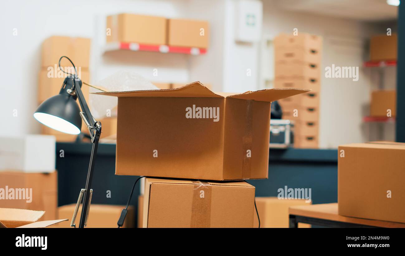 Empty storage room with cardboard boxes on shelves and racks, warehouse ...