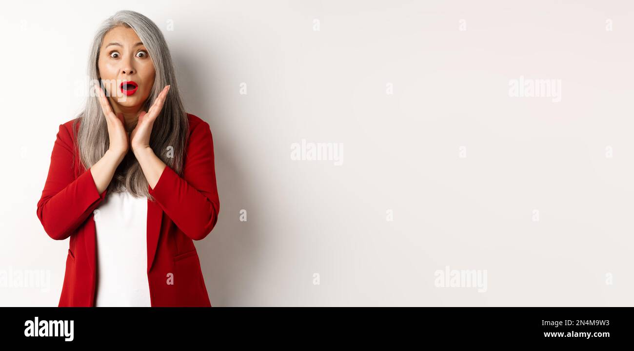Business people. Asian senior businesswoman in red blazer and makeup ...