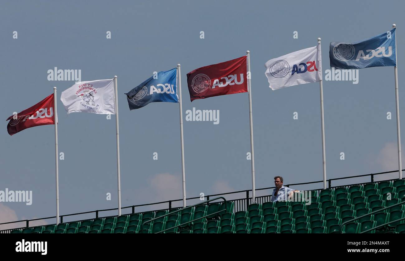 A fans sits in the grandstand on the 18th hole during a practice round ...