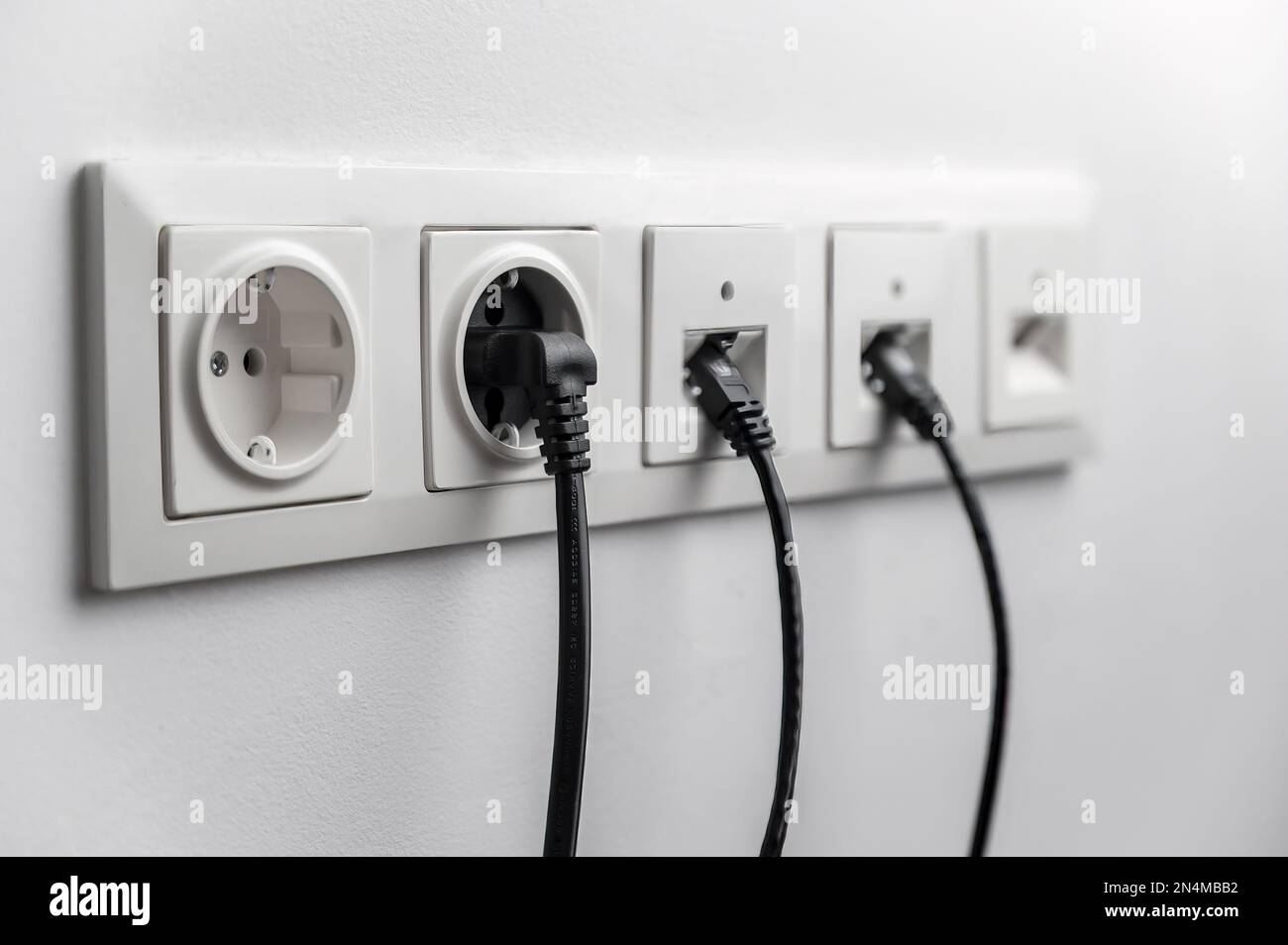 electrical and internet socket on a white wall in the room. Five ...