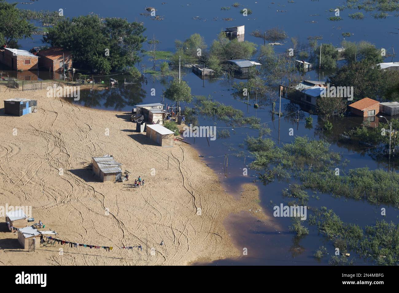 Homes are surrounded by floodwater in the Cateura neighborhood, seen ...