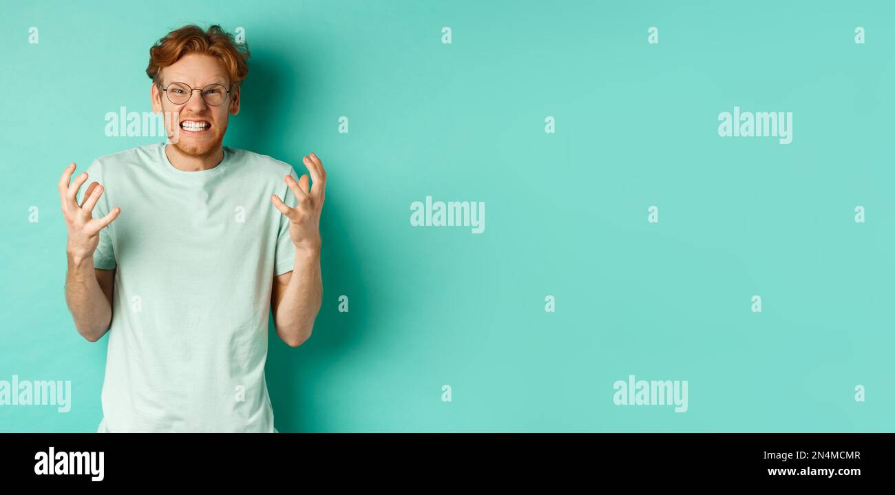 Portrait of distressed and angry redhead guy losing temper, shouting ...