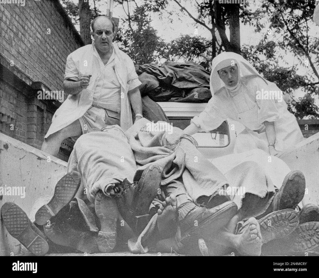 A nun in Elisabethville assists as bodies of Katangans, killed in ...