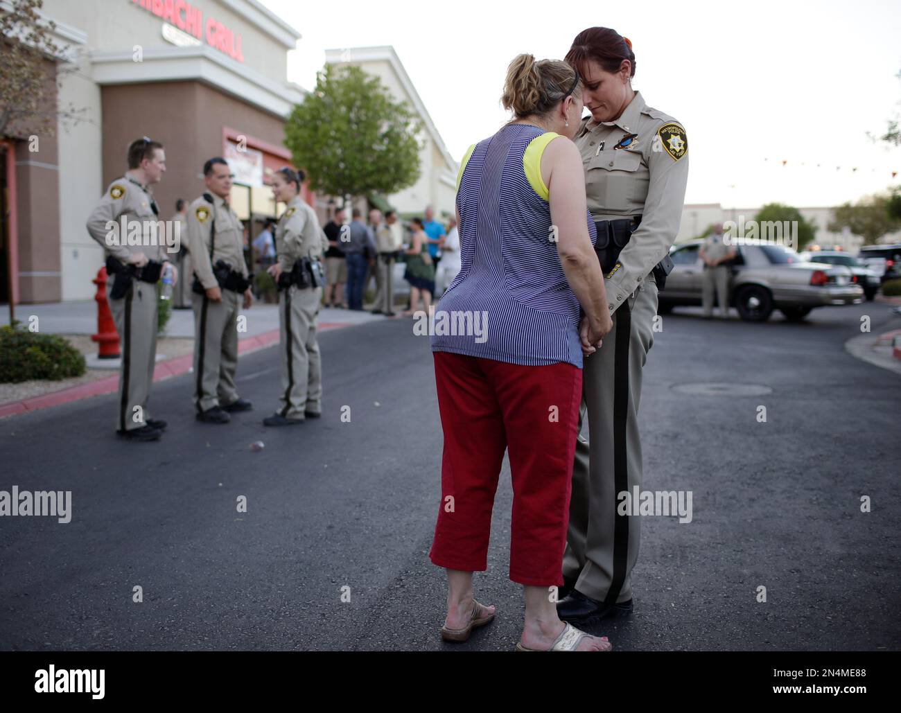 Cheri Rasmussen, left, prays with Las Vegas Metropolitan Police Lt ...