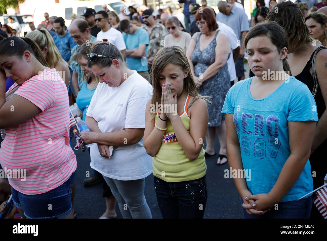 Alyssa Hernandez, center right, and Isabella Dominguez pray during a ...