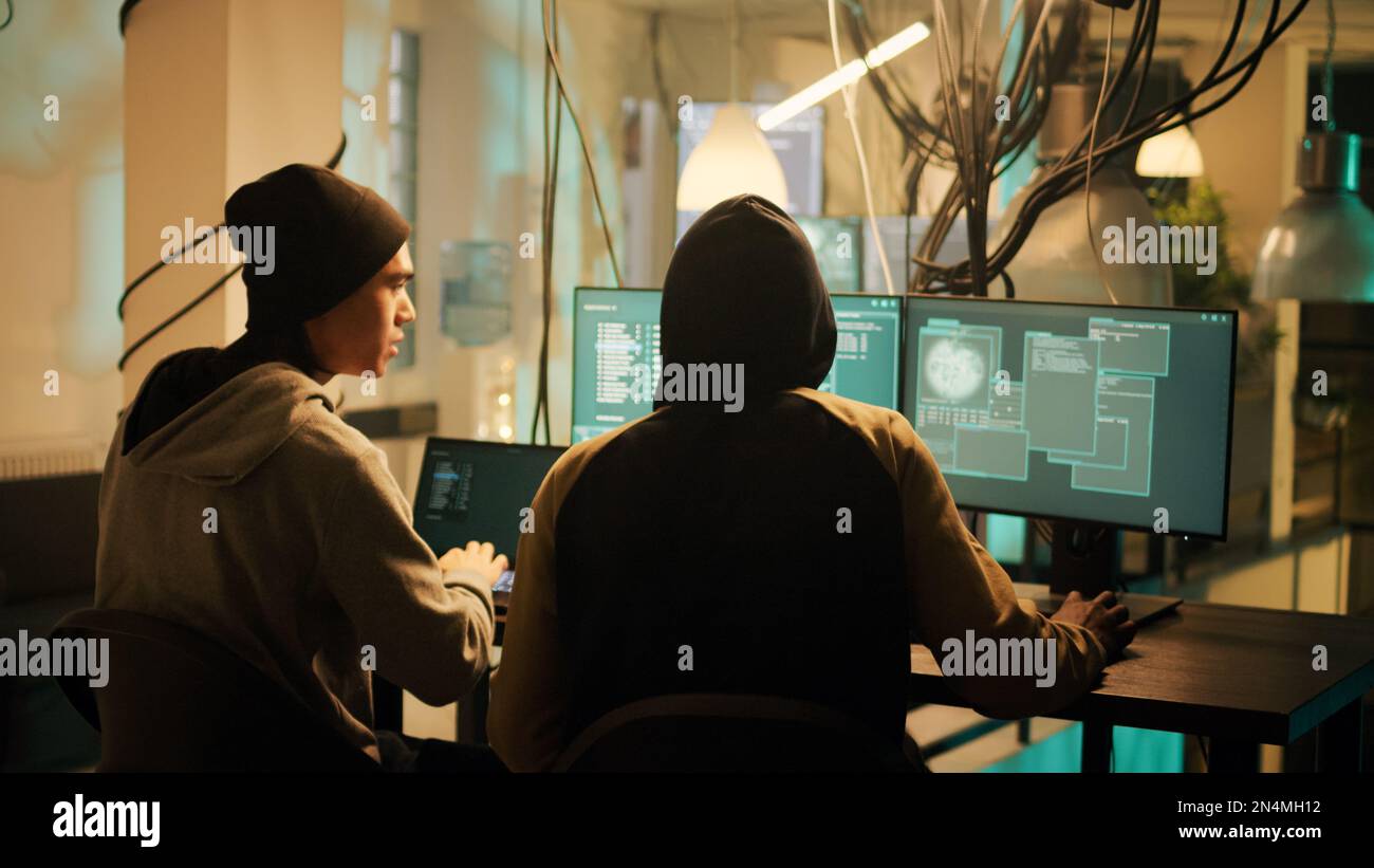 Hackers team working together to break security system on computer ...