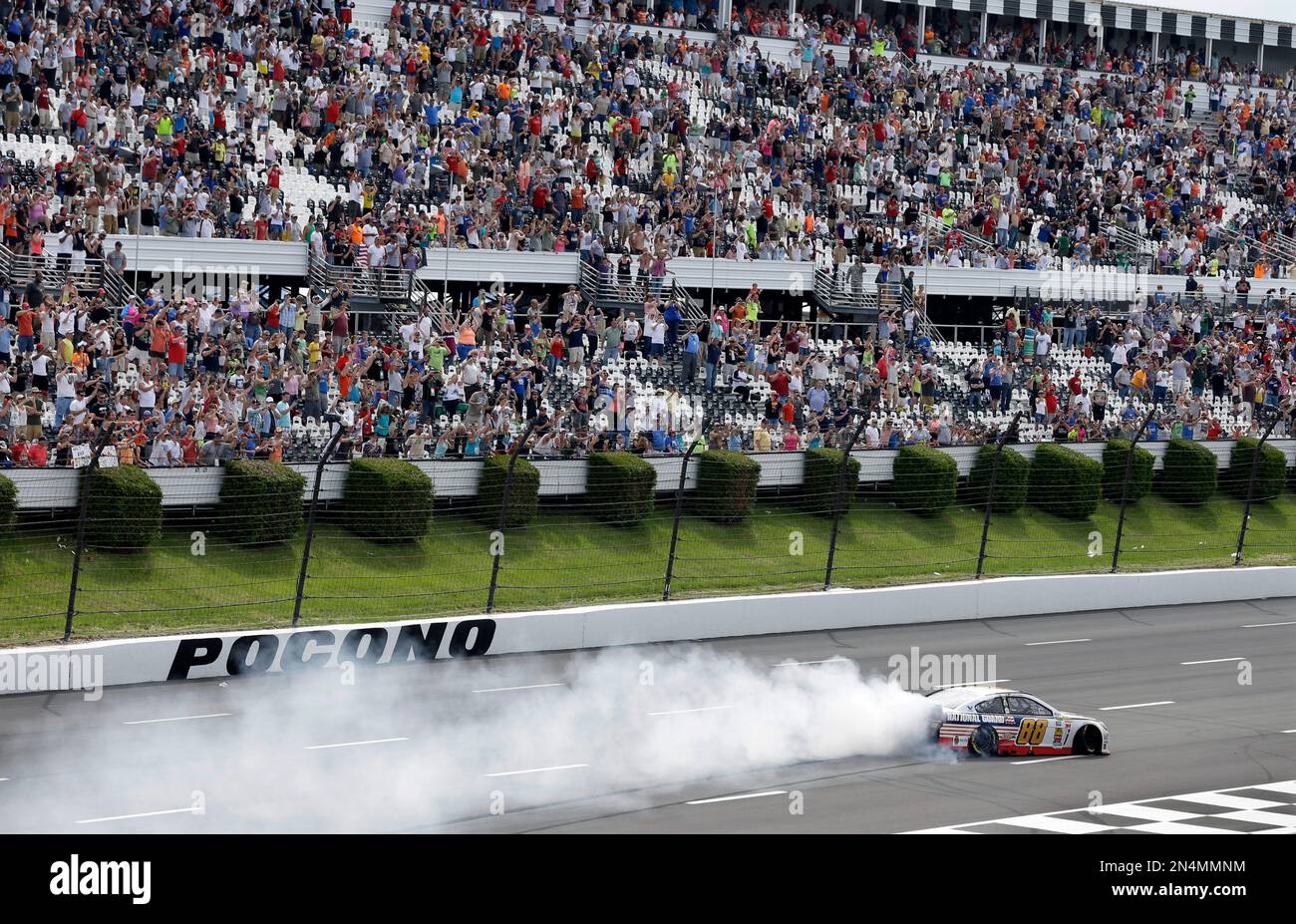 Driver Dale Earnhardt Jr. (88) does a burnout in front fans after ...