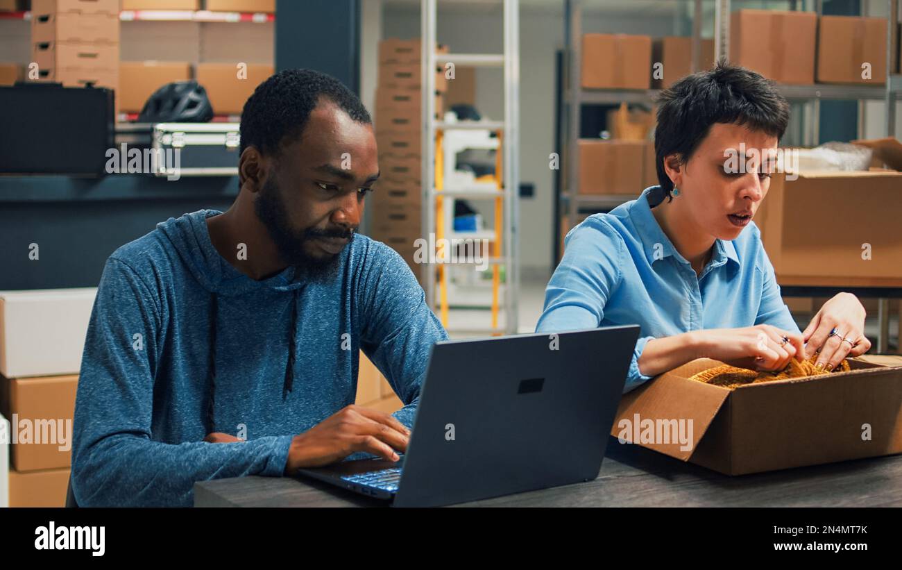 Diverse partners checking quality of goods before packing them in ...