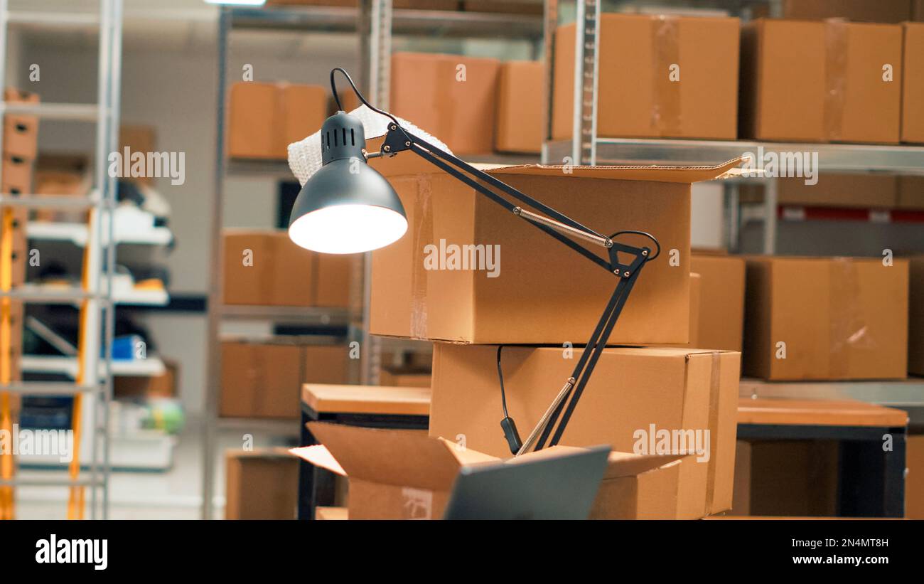 Storehouse filled with raw materials and shelves to put carton boxes ...