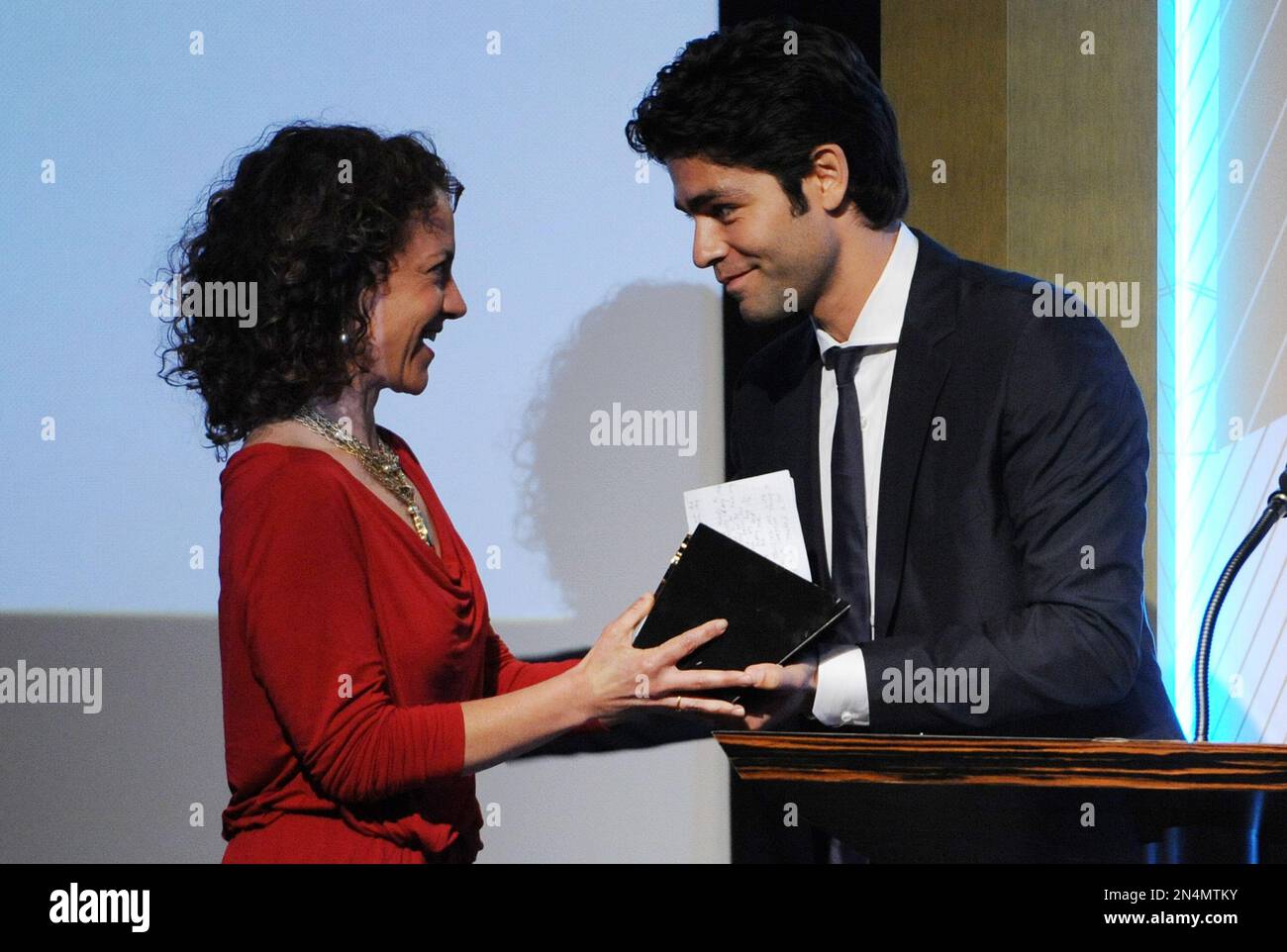 Actor Adrian Grenier, right, hands student filmmaker Helen Hood Scheer ...