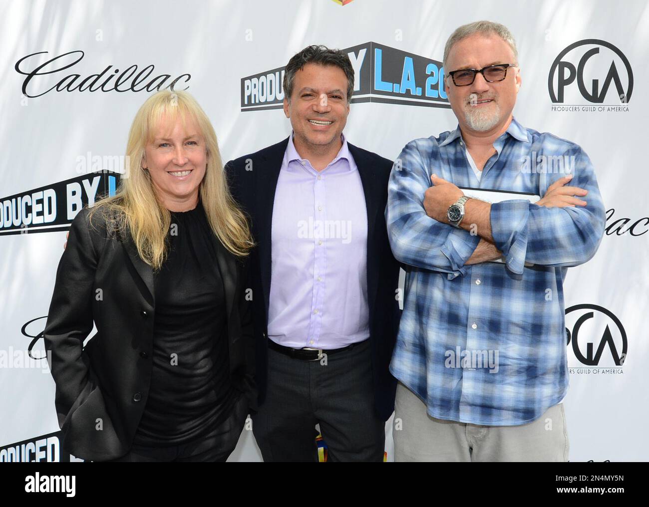 From left, Cean Chaffin, Michael DeLuca, and David Fincher arrive at ...