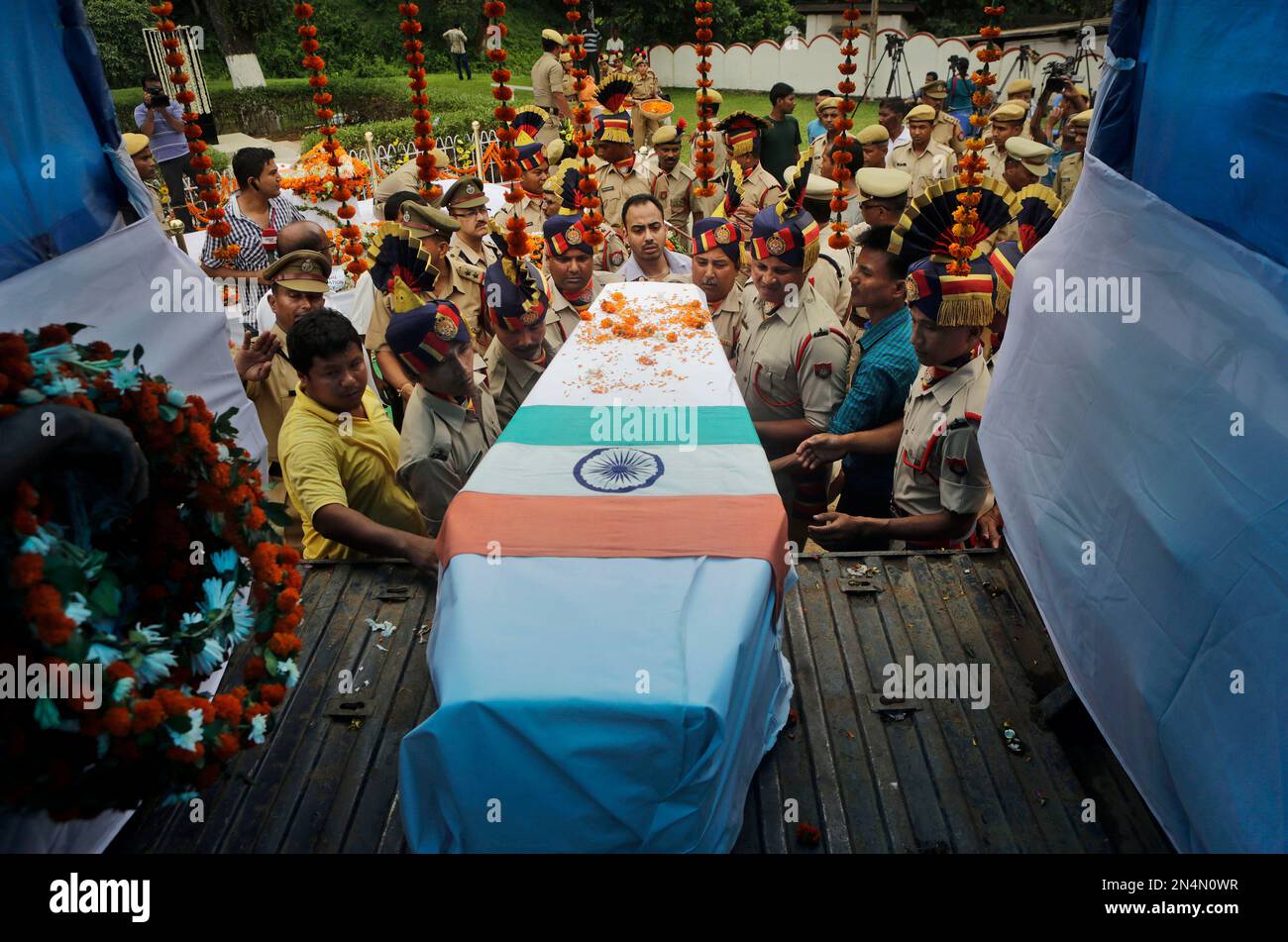 Indian police personnel stand near the coffin of Superintendent of ...
