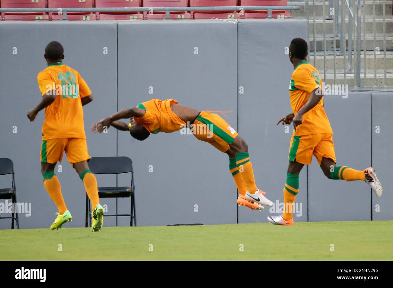 Zambia's Christopher Katongo, center, does a back flip with teammates ...
