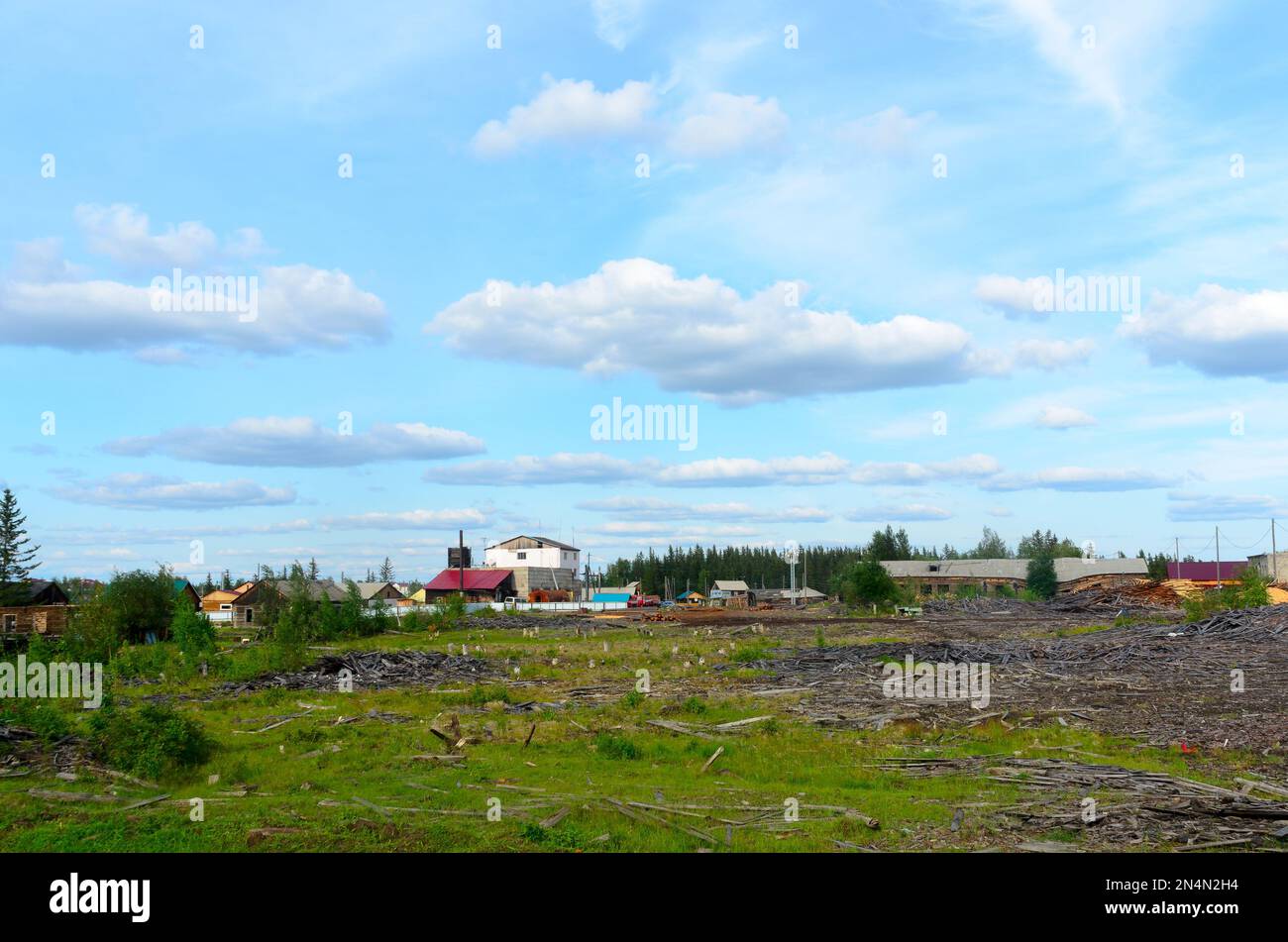 An old abandoned sawmill stands in the village on an empty field with a ...