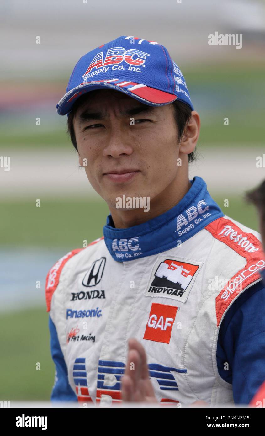 Takuma Sato, of Japan, walks the pitts before qualifications for an ...