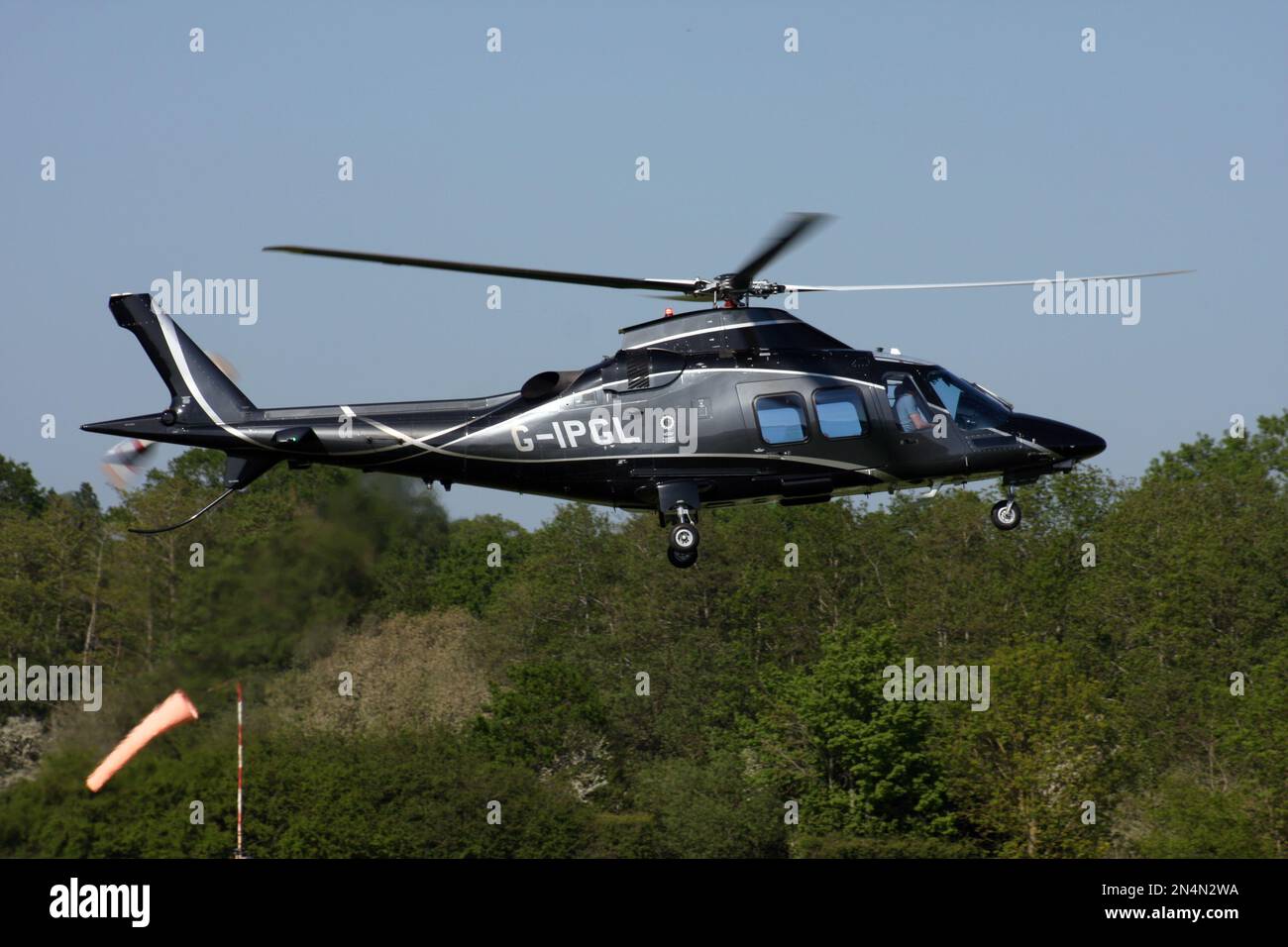 An Agusta-Westland AW-109SP departs Redhill Aerodrome Surrey England ...