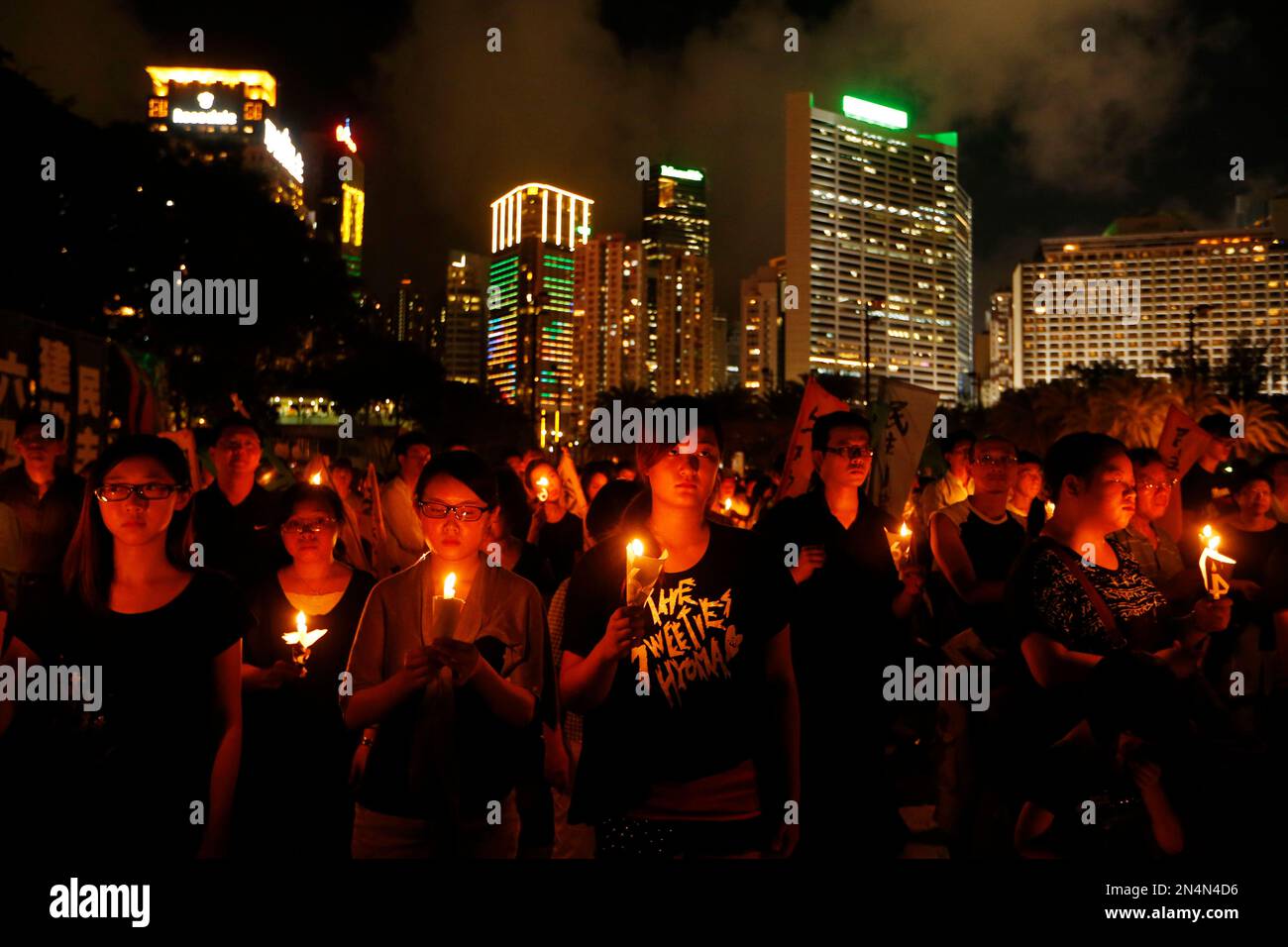 Tens of thousands of people attend a candlelight vigil at Victoria Park in Hong Kong Wednesday ...