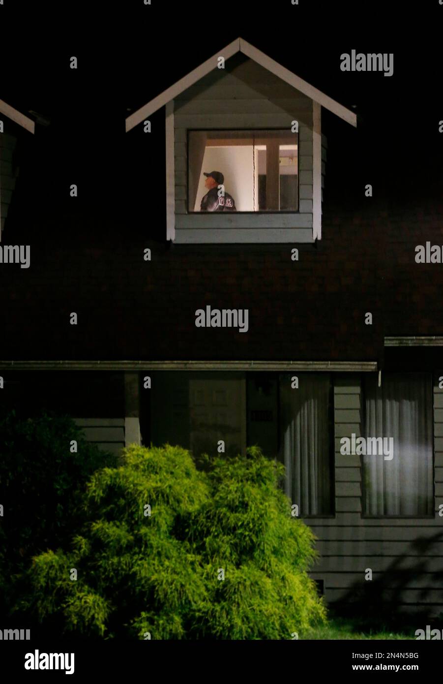 Police officers and detectives search a home believed to be tied to ...