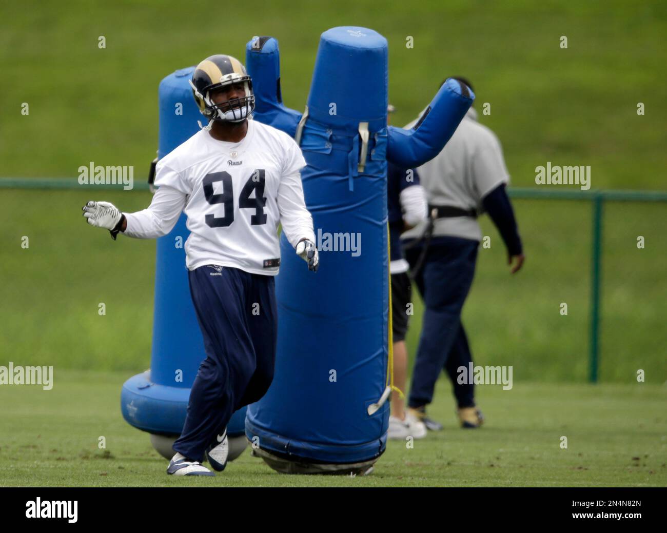St. Louis Rams defensive end Robert Quinn moves around a blocking dummy ...