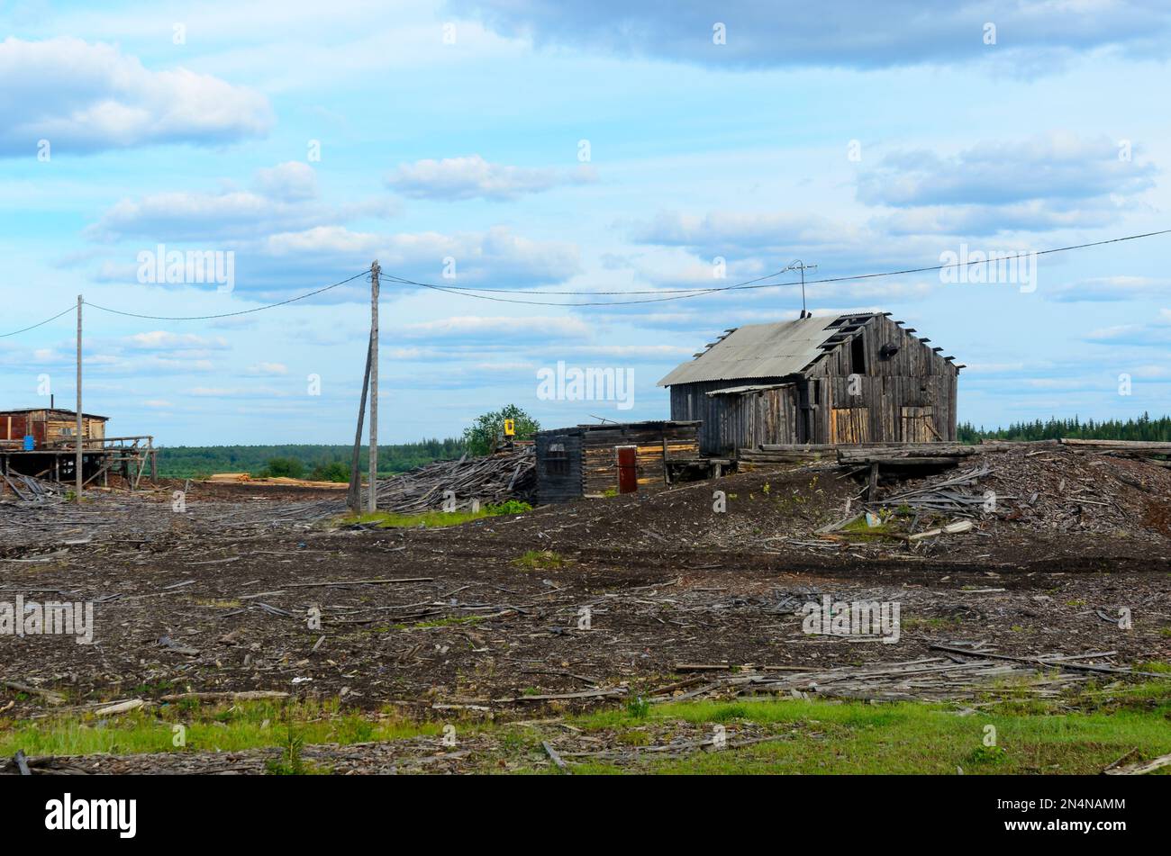 An old abandoned sawmill stands on the Bank of the Northern river and ...