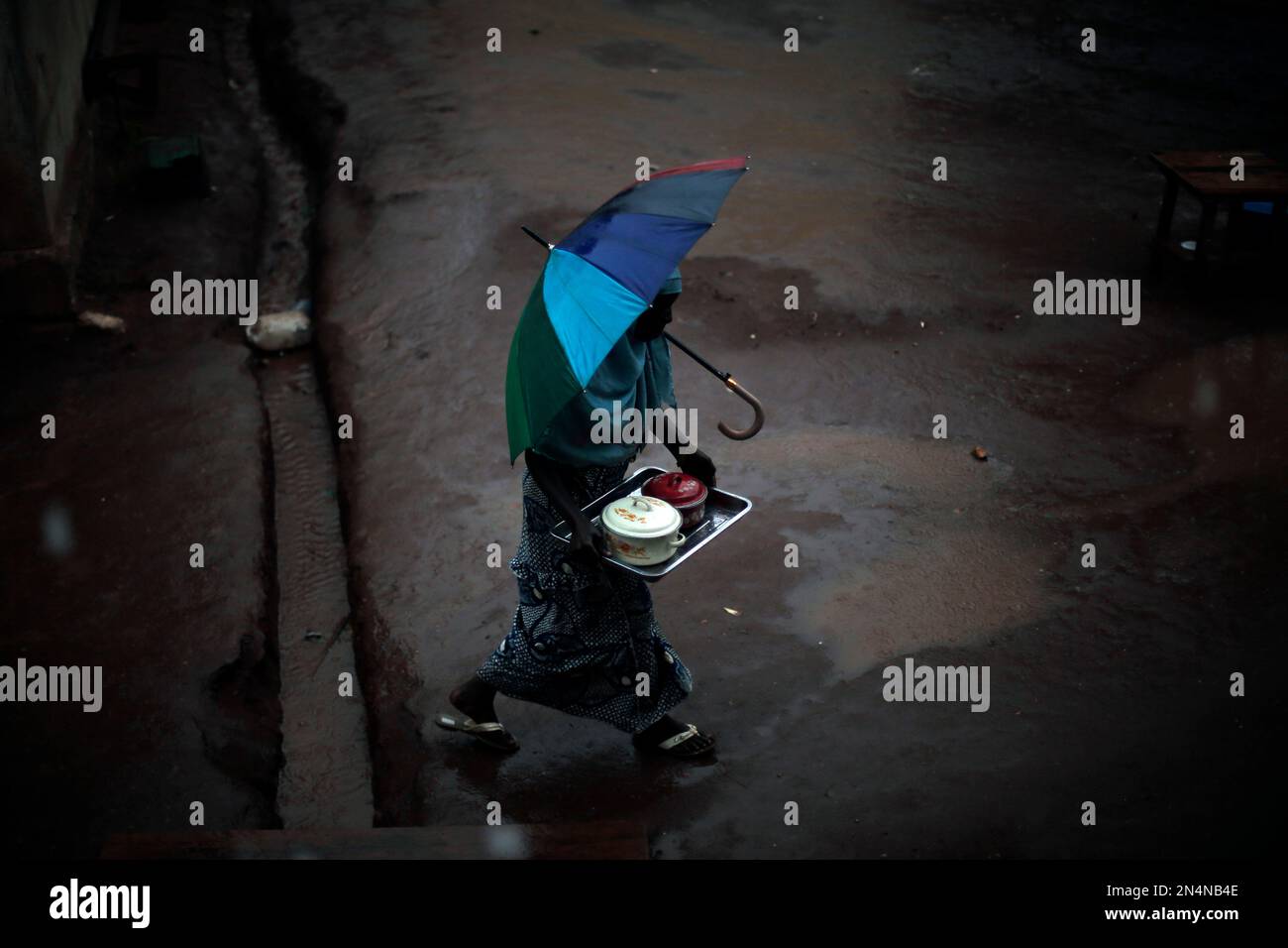In this Monday, April 14, 2014 photo, a Muslim refugee carries food ...