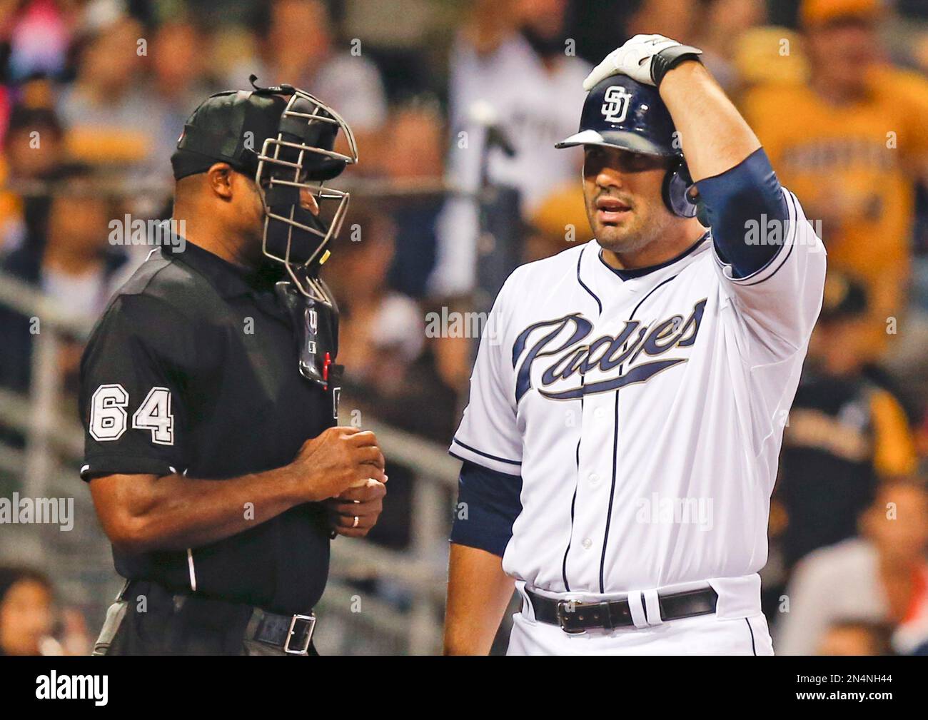 San Diego Padres' Carlos Quentin holds his helmet while disputing a ...