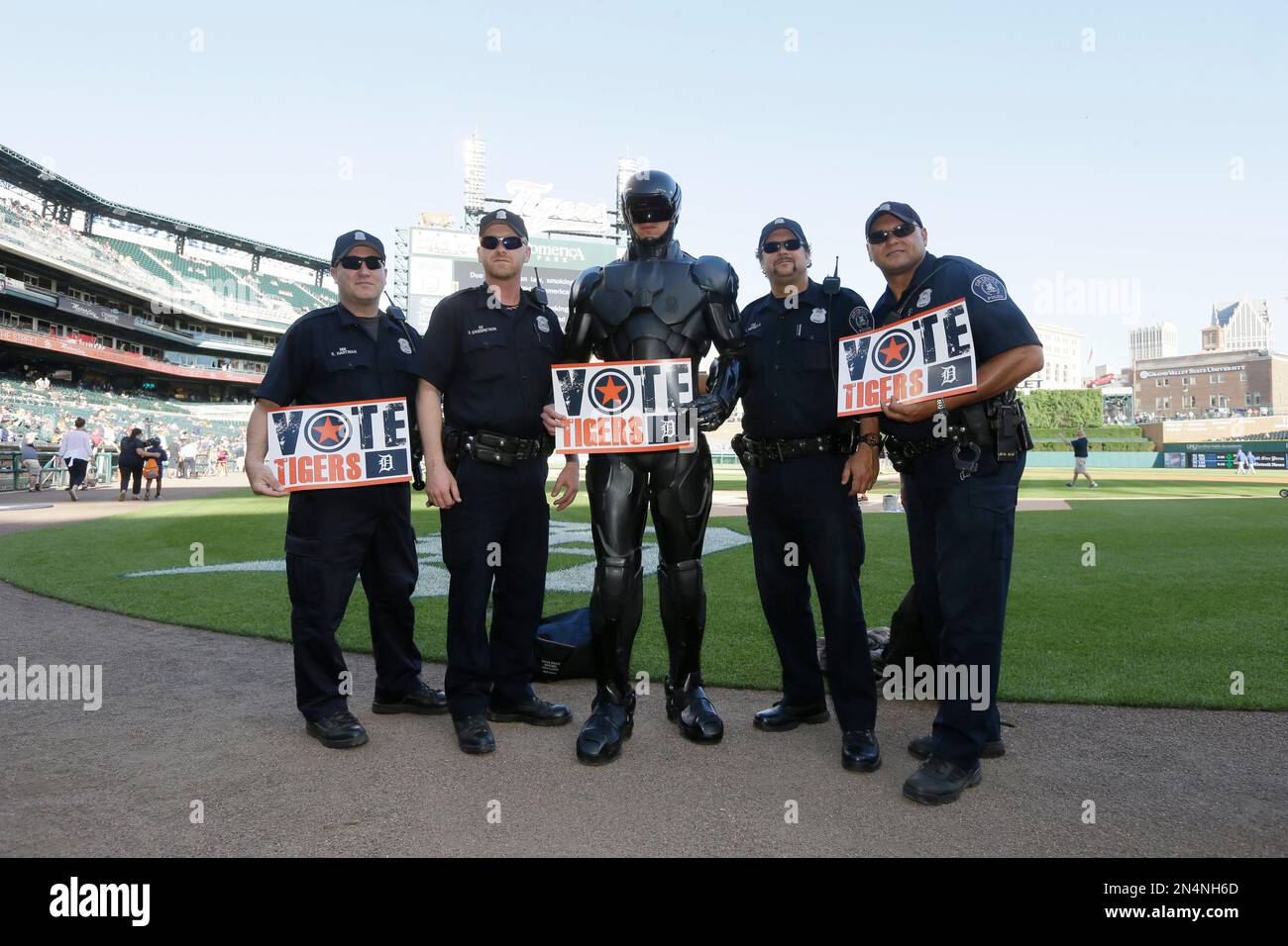 The movie character Robocop stands with Detroit police officers before ...