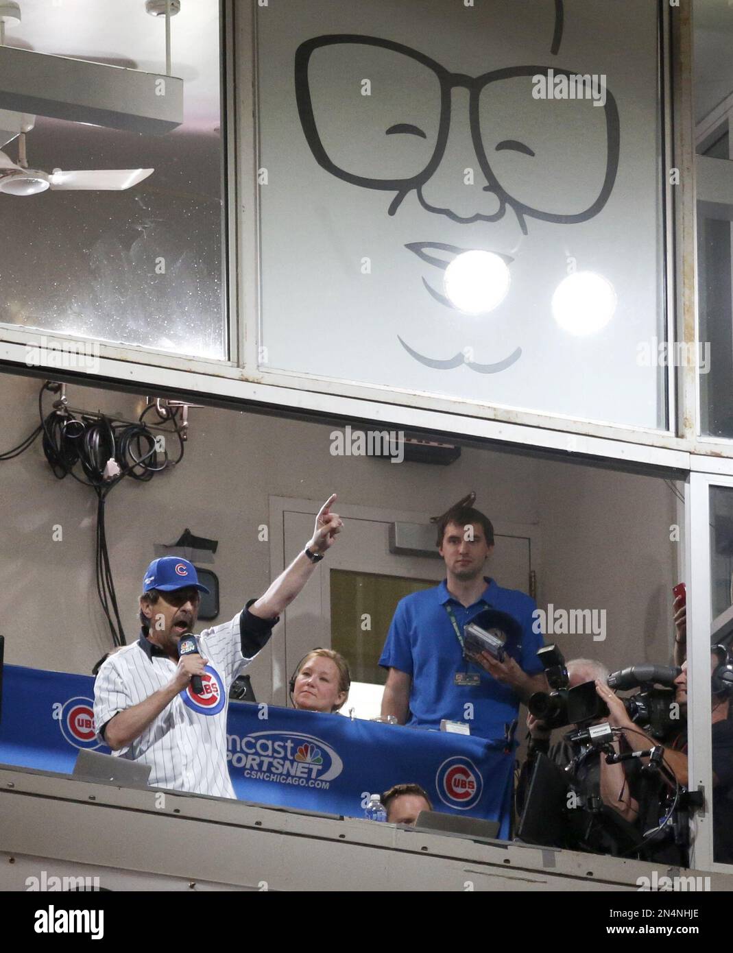 Actor Joseph Mantegna leads the Wrigley Field crowd in Take Me Out To ...