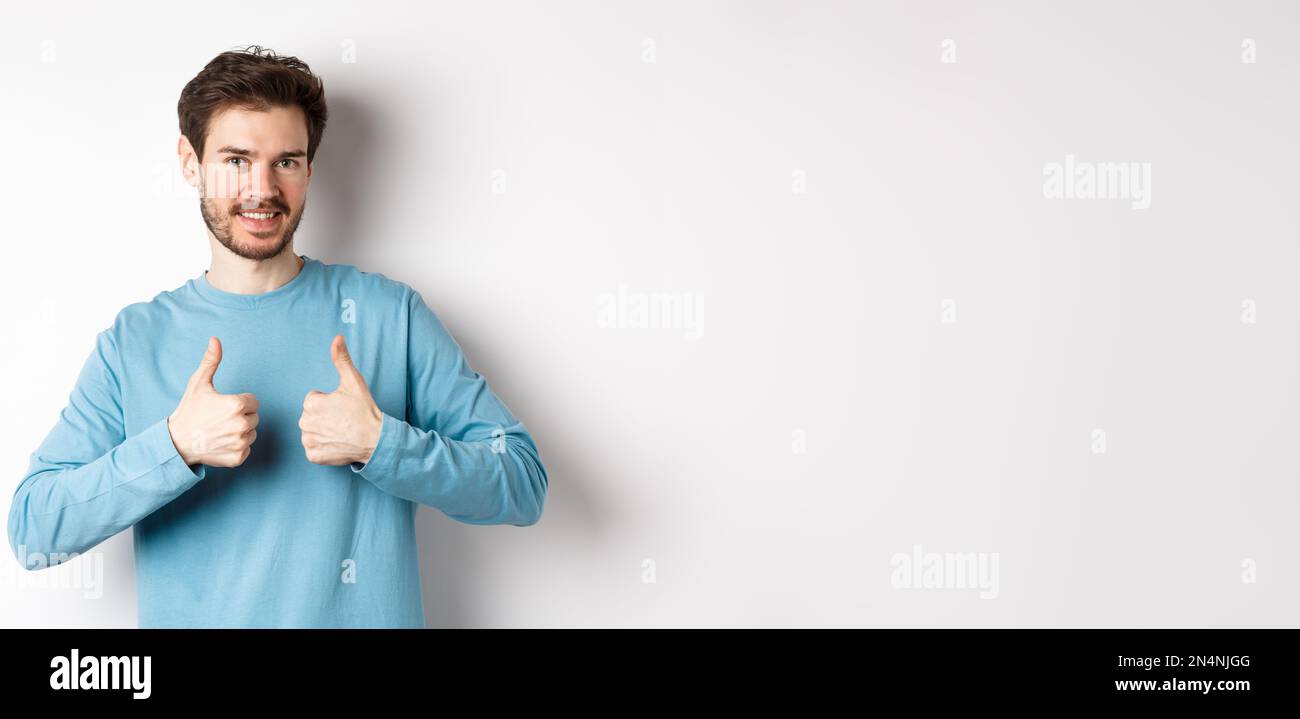 Good choice. Attractive caucasian man with beard showing thumbs up and ...