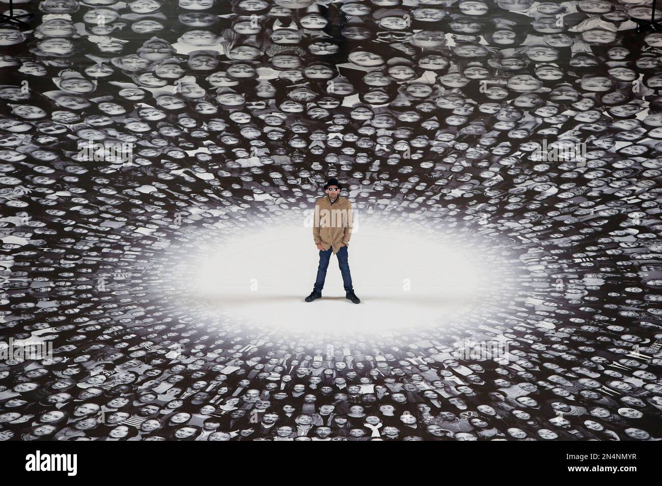 French street artist and photographer JR poses on his creation during ...