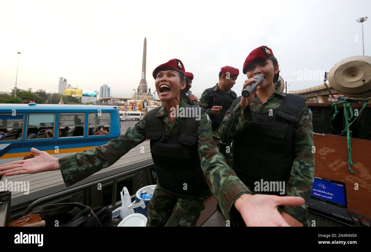 Thai female soldiers entertain passers by while providing security at ...