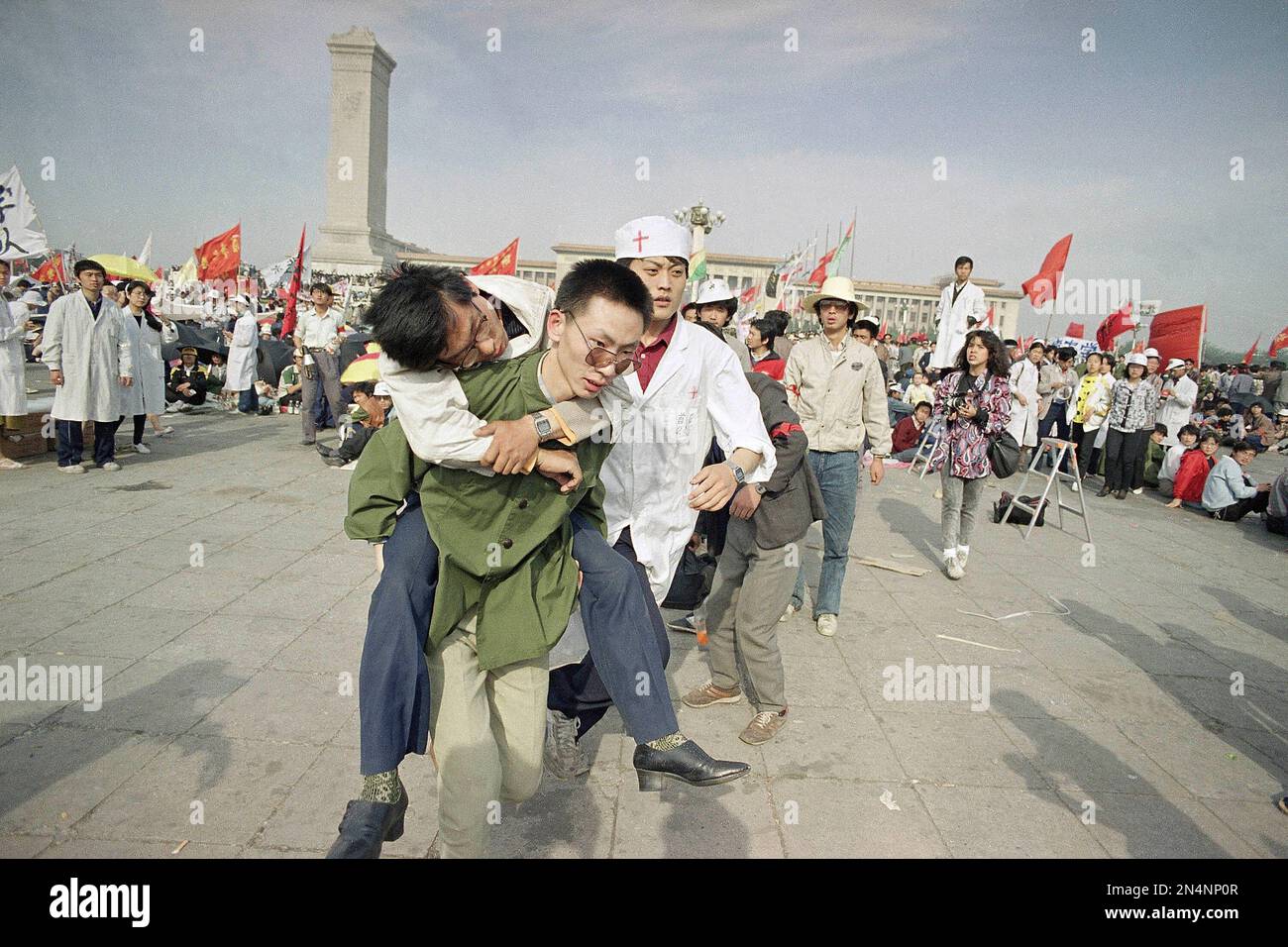 FILE - In this May 16, 1989 file photo, medics rush a Beijing ...